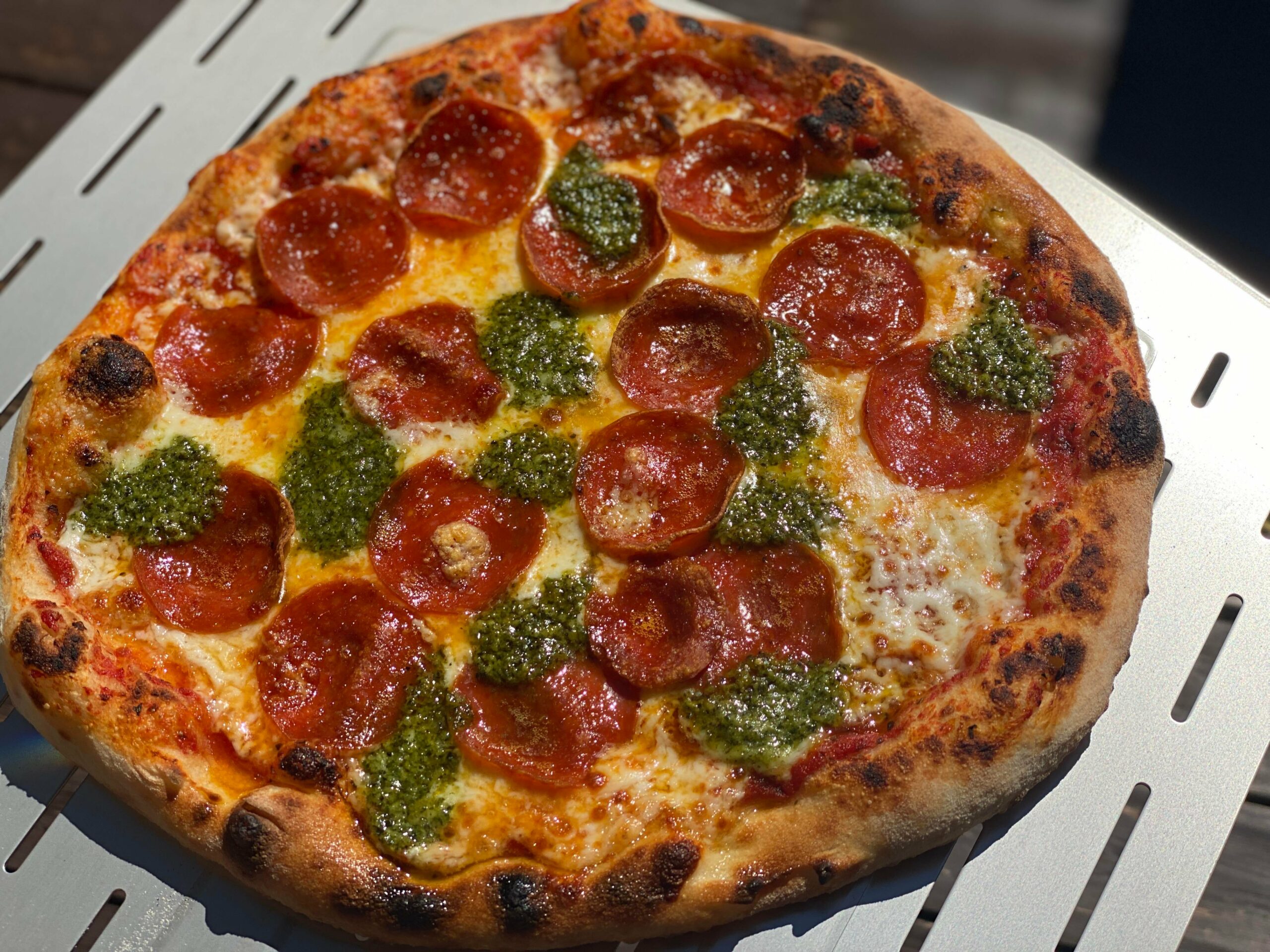 NY/Neapolitan hybrid- pepperoni with dollops of fresh pesto. Cooked ...