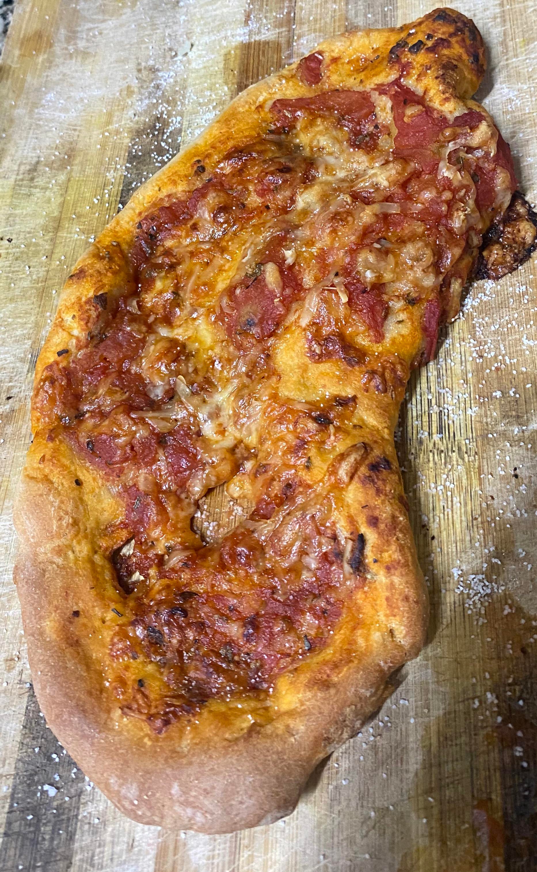 My first properly finished pizza after 8 attempts . Yes it's shaped ...